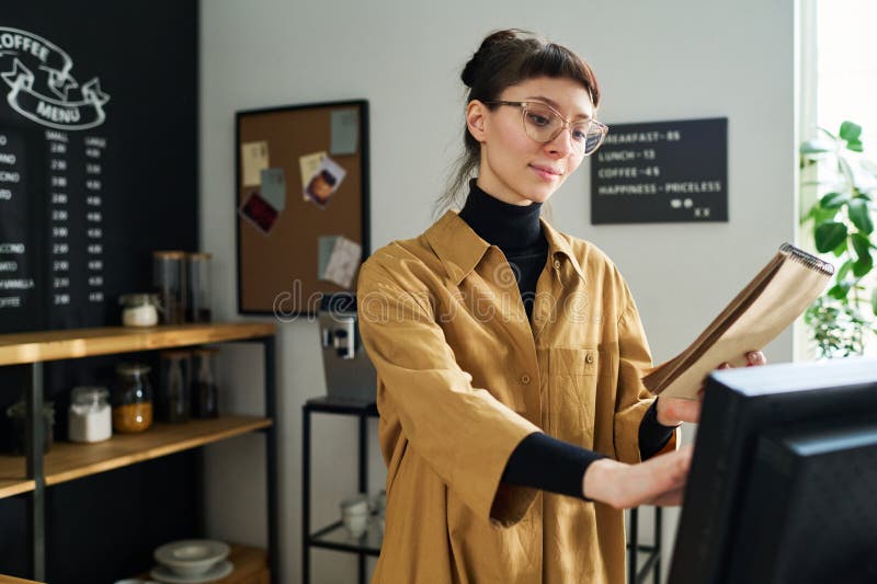 Waitress with Notepad Counting Price of Order while Entering Data in ...