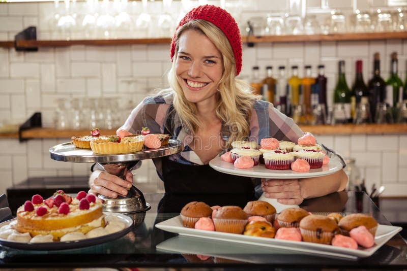 Waitress posing with cakes stock photo. Image of female - 77689486
