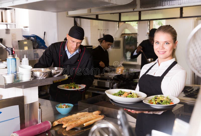 Waitress in Restaurant Kitchen with Ordered Meals Stock Photo - Image ...