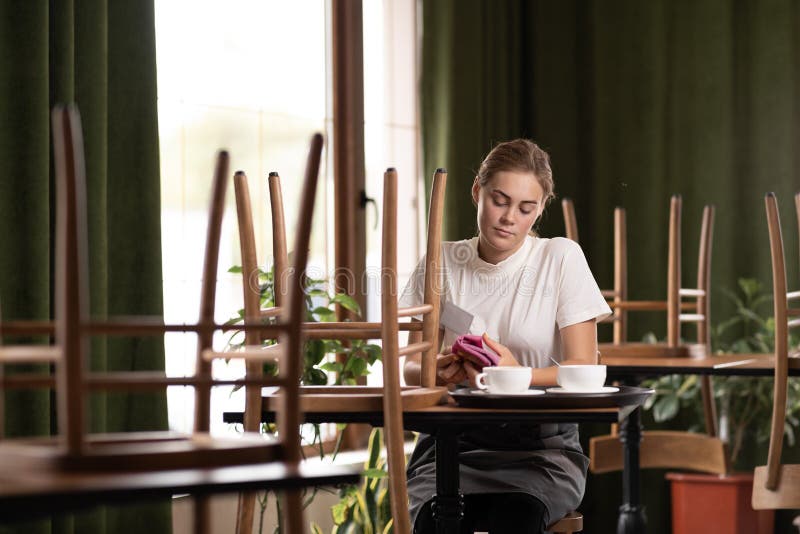 The Waitress is Resting Sitting at a Table in a Cafe, the End of the ...