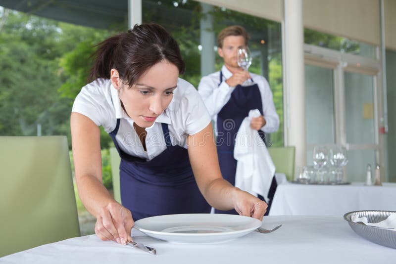 Waitress Setting Table in Restaurant Stock Photo - Image of uniform ...