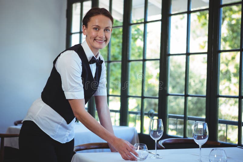 Waitress setting the table stock photo. Image of classy - 68237762