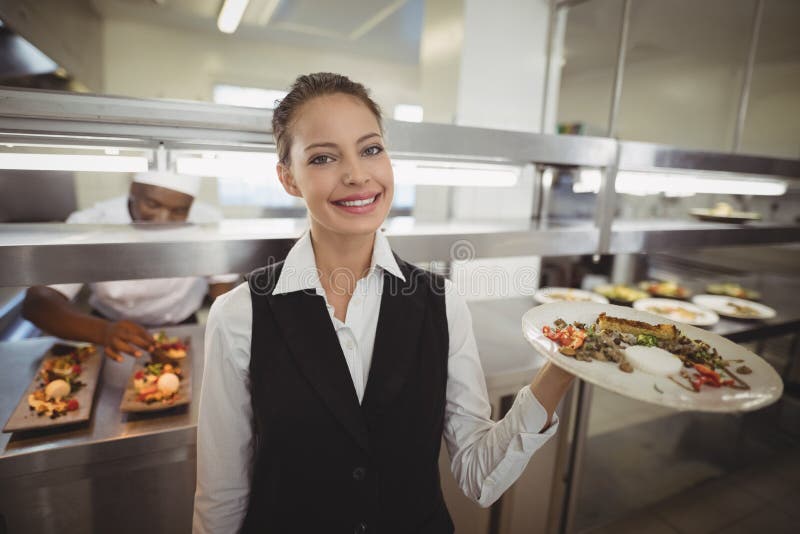 Chef and Waitress Showing Food Dishes To the Camera Stock Image - Image ...