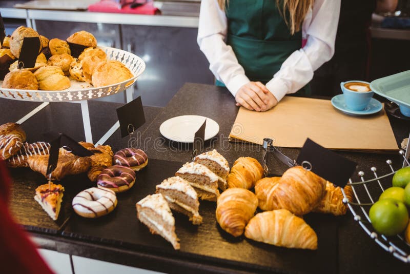 Waitress Behind the Counter Giving Cake To Customer Stock Photo - Image ...