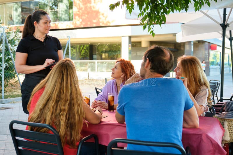 Waitress Taking an Order for a Group of Mature Friends in a Restaurant ...