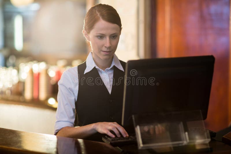 Waitress Using a Computer at Counter Stock Photo - Image of indoors ...