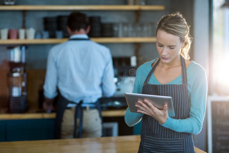 Waitress Using Digital Tablet at Counter Stock Image - Image of ...