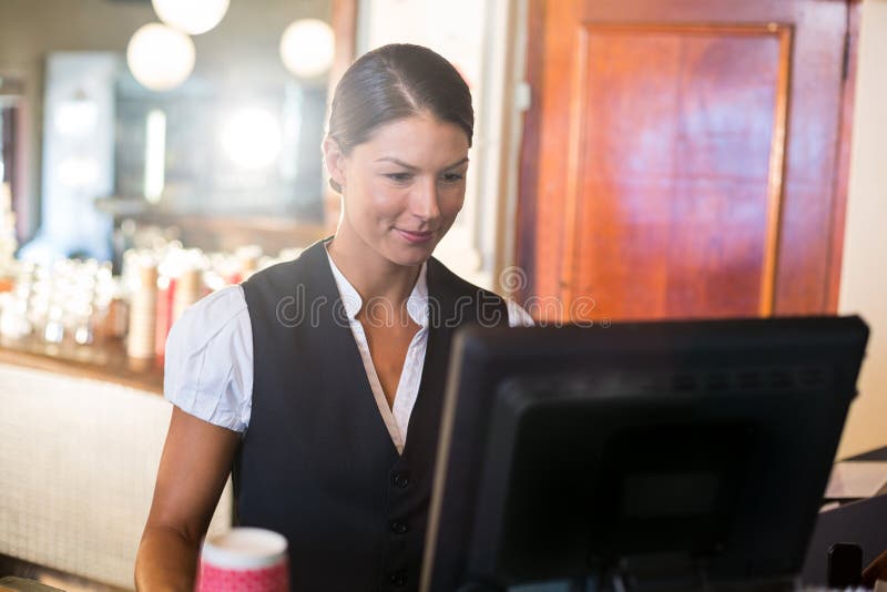 Waitress Working on Computer at Counter Stock Image - Image of uniform ...
