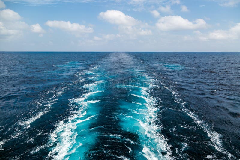 Boat wake and cargo ship stock image. Image of freighter - 26352365