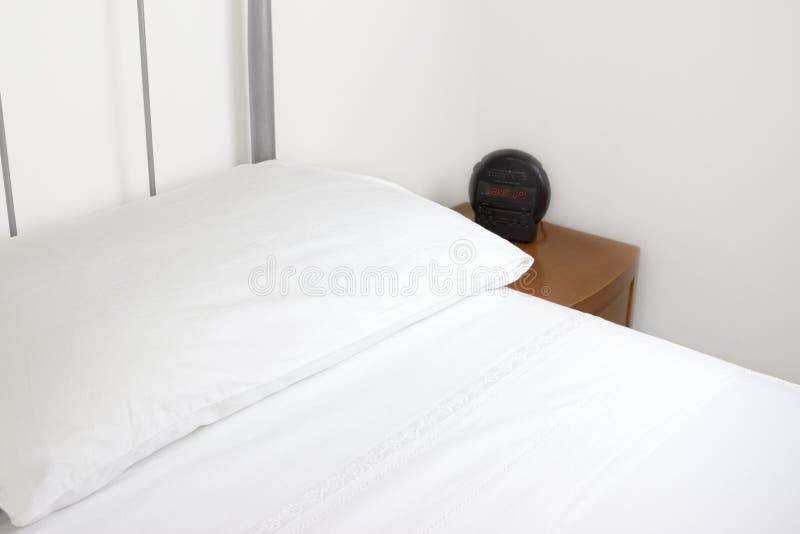 Wake Up Alarm Clock on Empty Bed Stock Photo - Image of front ...