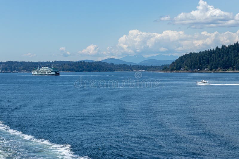 Wake in Water from Boat with Washington State Ferry in the Background ...