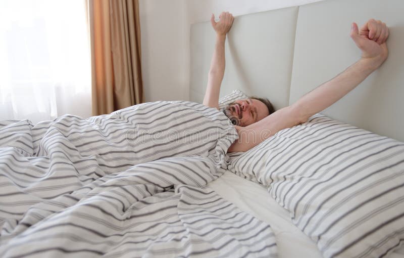 Waking up man stock photo. Image of interior, arms, happy - 71431312