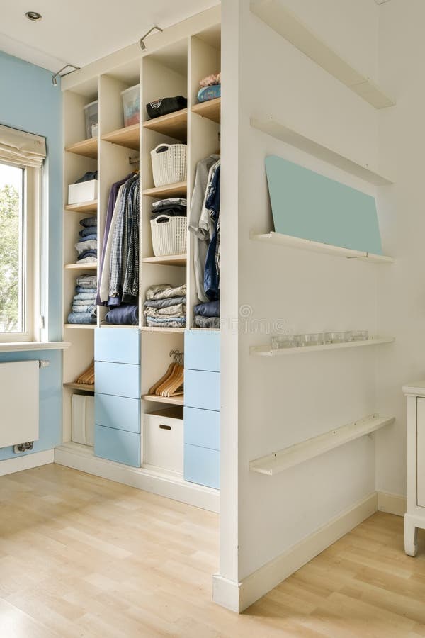 A Walk in Closet with Blue Walls and White Shelves Stock Image - Image ...