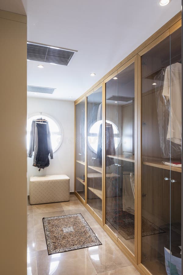 Walk-in Closet in Wood and Marble with Large Round Lighted Window Stock ...