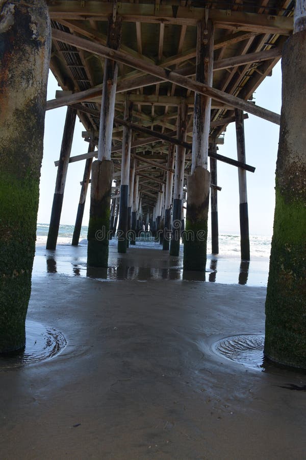 A Walk under a pier stock photo. Image of tide, waves - 108256862