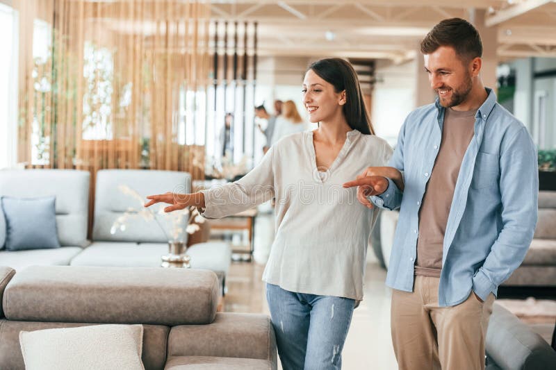 Walking Around. Couple Choosing the Sofa and Bed in the Store Stock ...