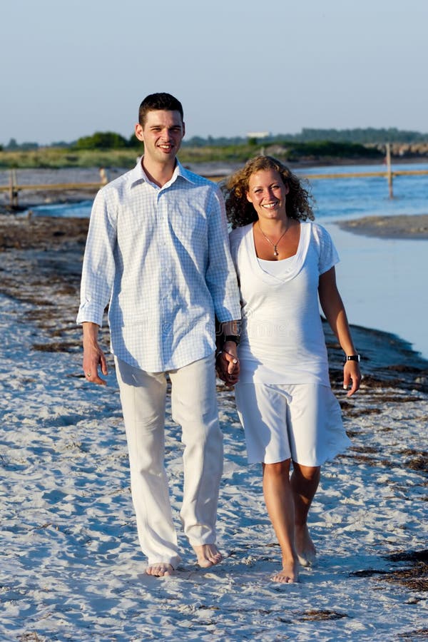 Couple Walking on the Beach Stock Photo - Image of female, arms: 5046456