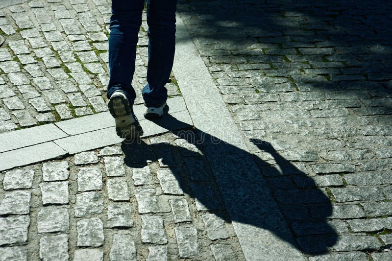 Walking on Cobblestone Casting Shadow Editorial Stock Photo ...
