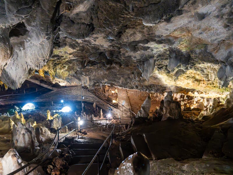 Walking Down Stairs Deep Inside Illuminated Cave Stock Photo - Image of ...