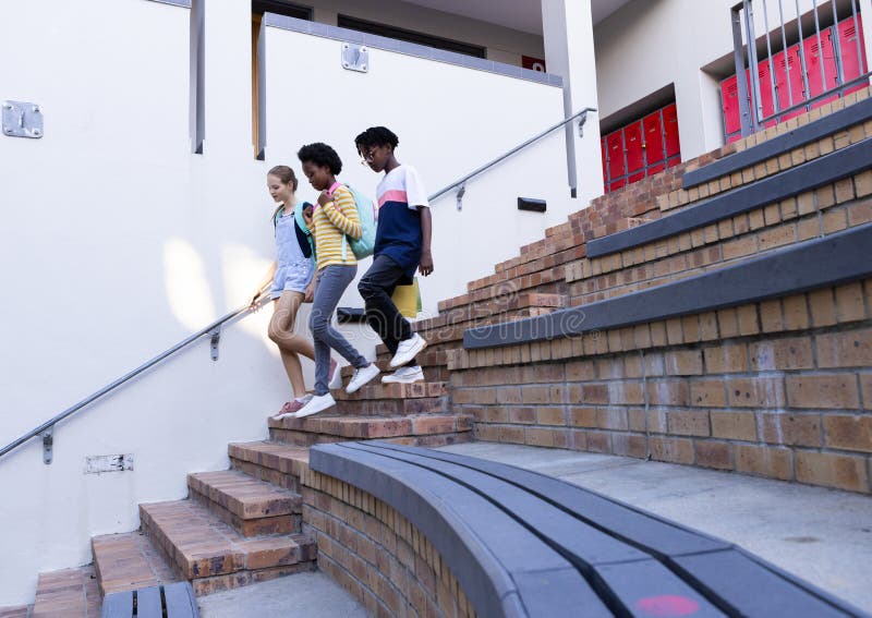 Walking Down Stairs, Three School Diverse Kids Talking and Holding ...