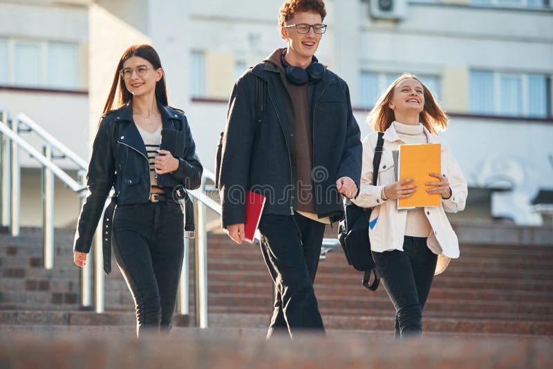 Walking Down the Stairs. Three Young Students are Outside the ...