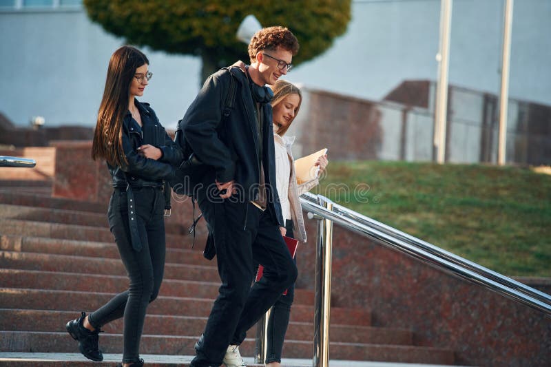Walking Down the Stairs. Three Young Students are Outside the ...