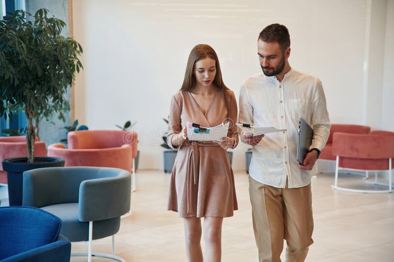 Walking Forward, Holding Documents. Man and Woman are on the Way To ...