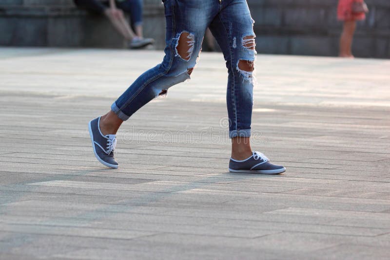 Walking Man in Ripped Jeans Stock Image - Image of shoe, activity: 75068747