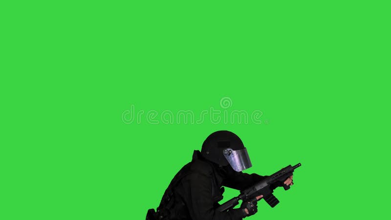 Special Forces Unit Shooting from Sitting Position on a Green Screen ...