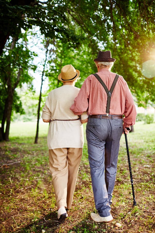 Walking in the park stock photo. Image of friendship - 75984972