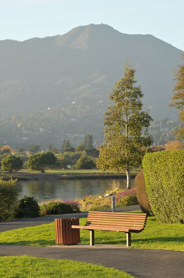 Walking Path with a Bench Under a Mountain Stock Photo - Image of color ...