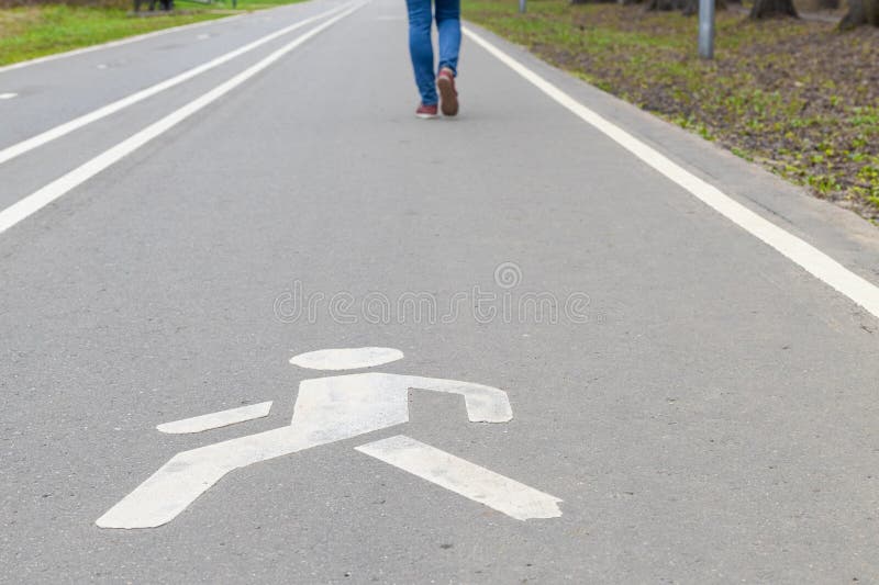 Walking Path in the Park with a Sign on the Pavement Stock Photo ...