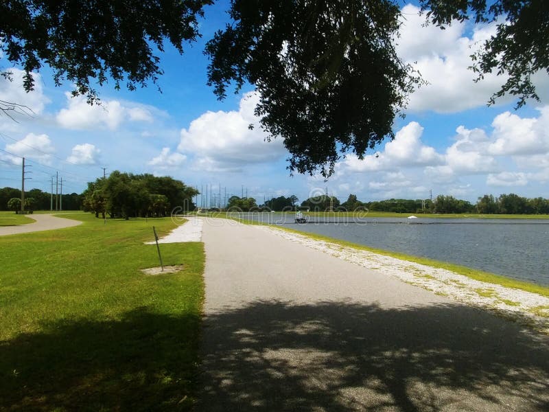 Walking Path Under a Bright Sunny Blue Sky with White Fluffy Clouds ...