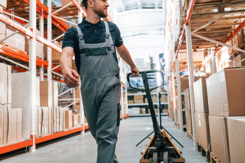 Walking with Platform Trolley. Employee in Uniform is Working in the ...