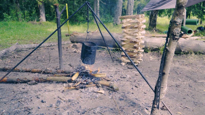 Walking Pot with Water Hanging on a Tripod Over the Fire Stock Footage ...