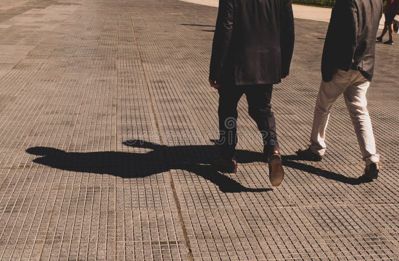 Walking on the sidewalk stock image. Image of brown - 228086907