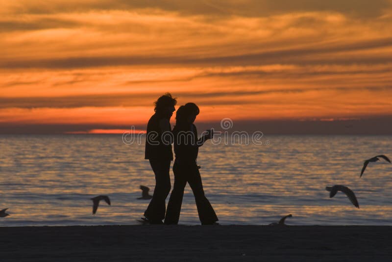 Walking at Sunset stock image. Image of sunset, water - 7889587