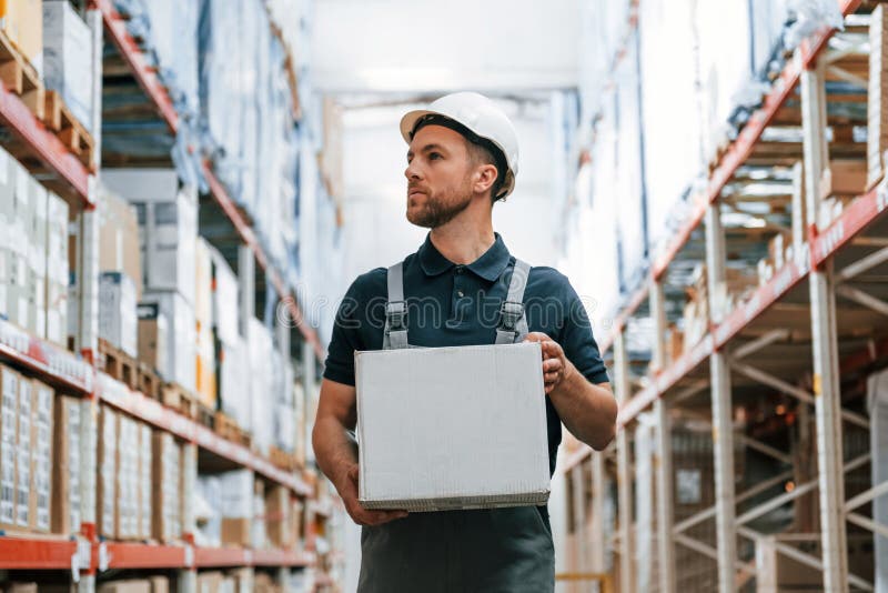 Walking with White Box in Hands. Employee in Uniform is Working in the ...