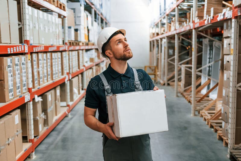 Walking with White Box in Hands. Employee in Uniform is Working in the ...