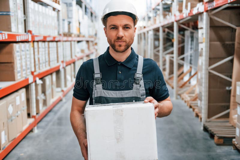 Walking with White Box in Hands. Employee in Uniform is Working in the ...