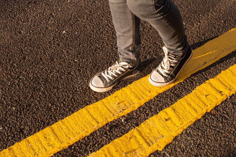 Walking on Yellow Street Lines Stock Photo - Image of footpath, legs ...