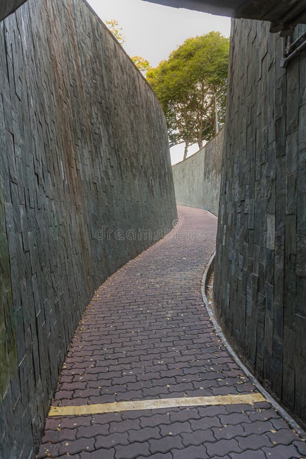 Walkway Made of Bricks and High Bricks Wall Along the Pathway Stock ...