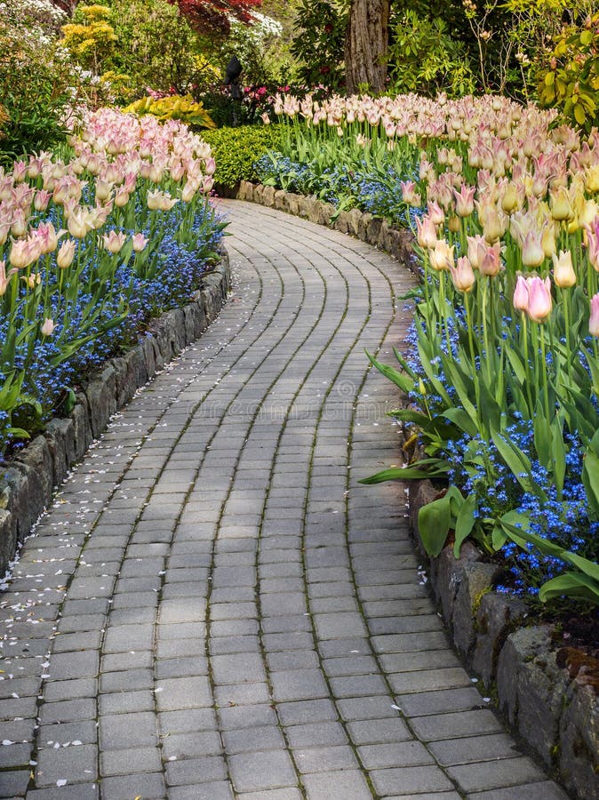 Walkway in a spring garden stock image. Image of flowerbed - 33200053