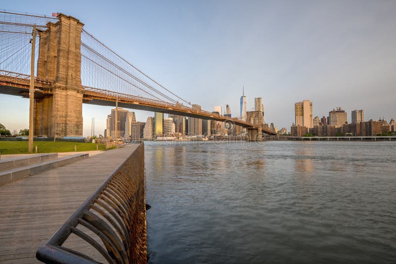 Walkway Under the Brooklyn Bridge with the New York Skyline Stock Image ...