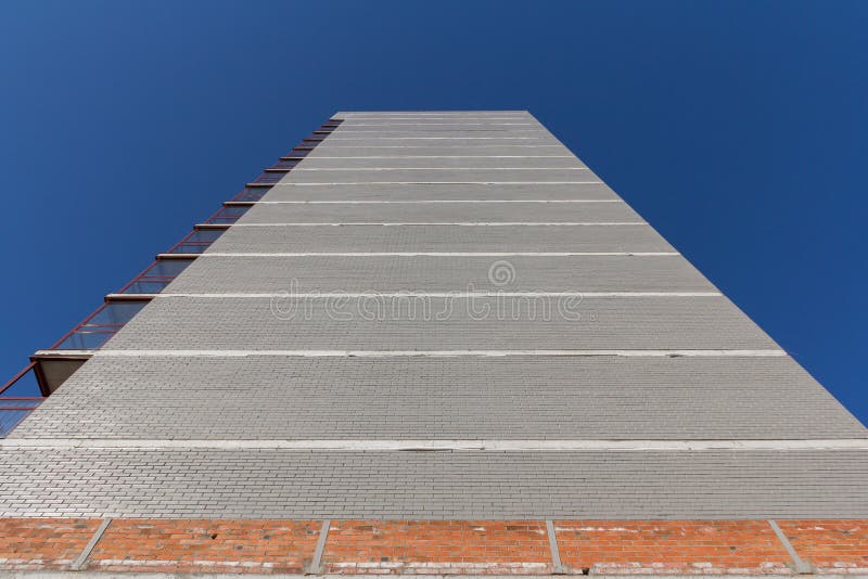 The Wall of a Brick Building Under Construction. a Look Up. Blue Sky ...