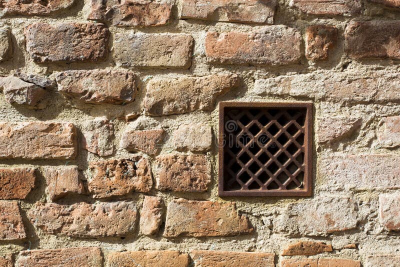 Wall of brick with grate stock photo. Image of closeup - 69906528