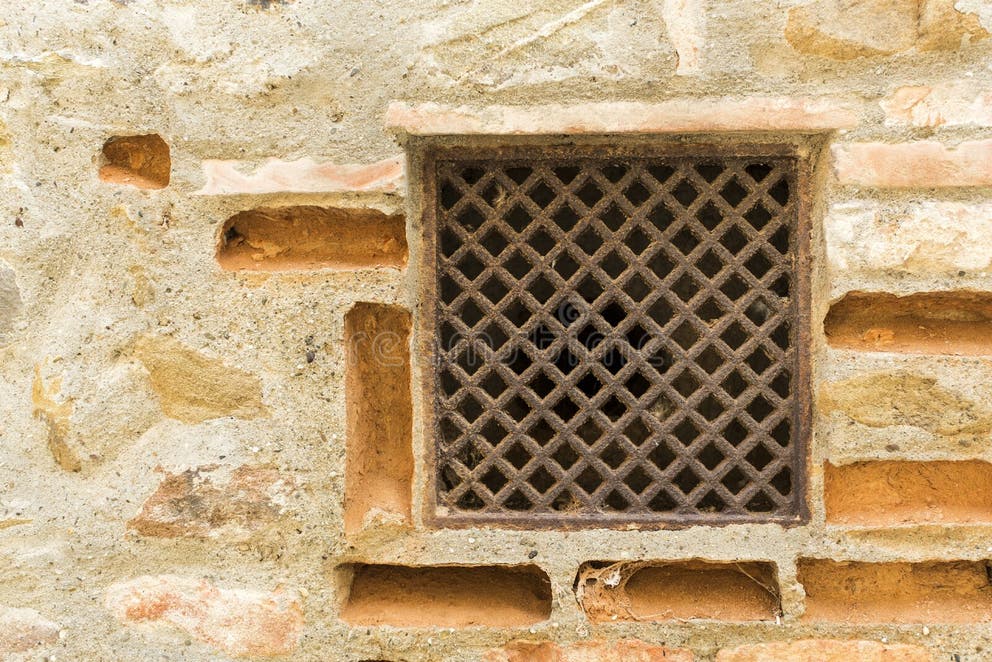 Wall of bricks with grate stock photo. Image of cement - 33147906