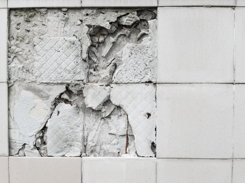 A Wall with a Broken Off Gray Tile from the Wall Stock Photo - Image of ...