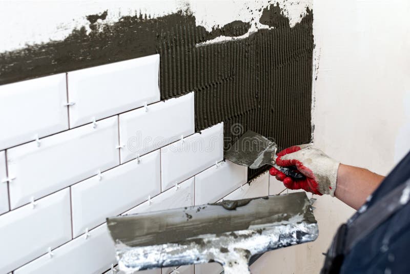 Wall Cladding. the Master& X27;s Hands Apply Tile Glue To the Walls ...