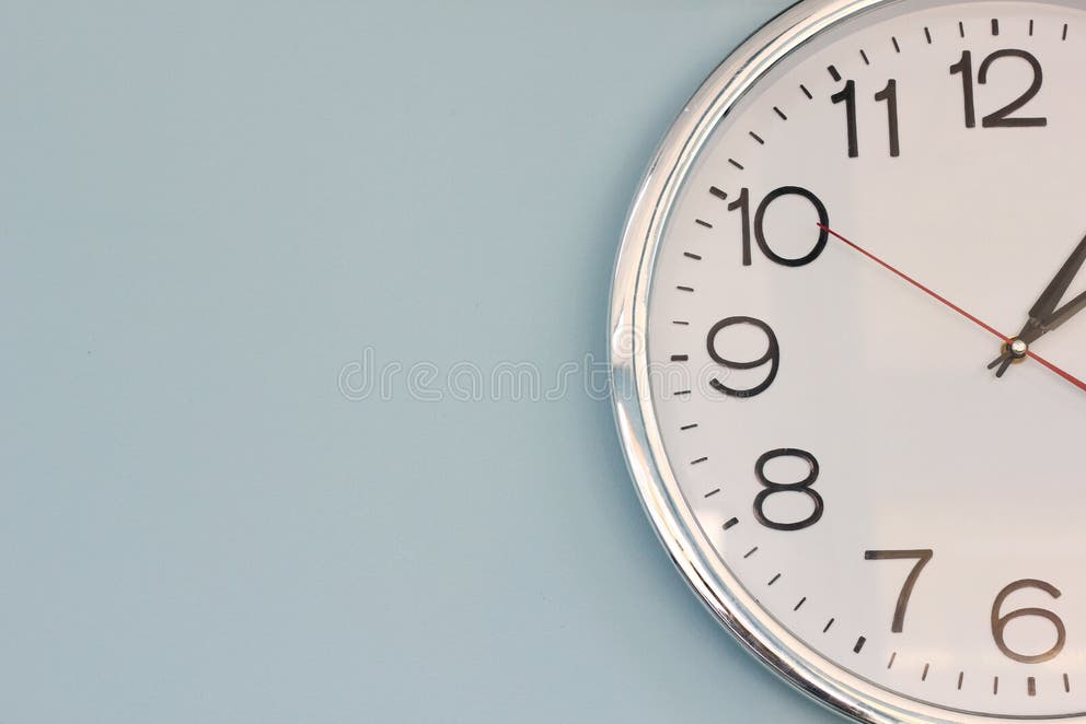 Simple Wall Clock Hanging on a Blue Wall Stock Photo - Image of grass ...